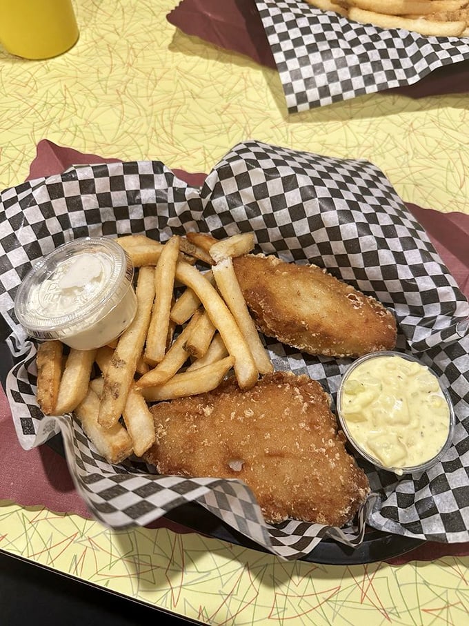 Fried cod that would make a New Englander nod in approval, served with fries that deserve to be fought over.