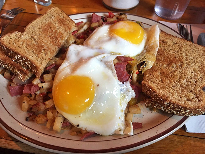 
The interior's pendant lighting casts a warm glow over wood-paneled walls&mdash;like dining inside a perfectly toasted marshmallow.