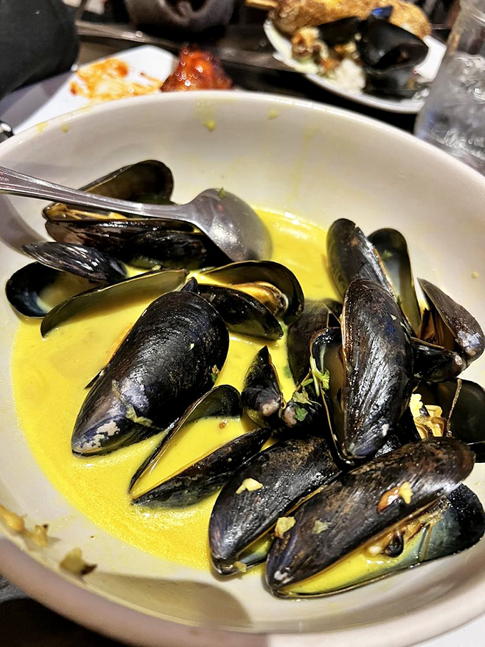 Mussels bathing in buttery broth, waiting to be rescued by bread. A seafood moment worth savoring. 