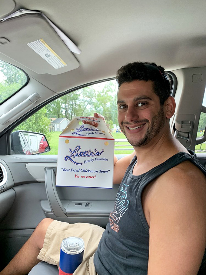 The ultimate trophy: a takeout box of Lettie's "Best Fried Chicken in Town." That smile says it all&mdash;mission accomplished, happiness acquired.