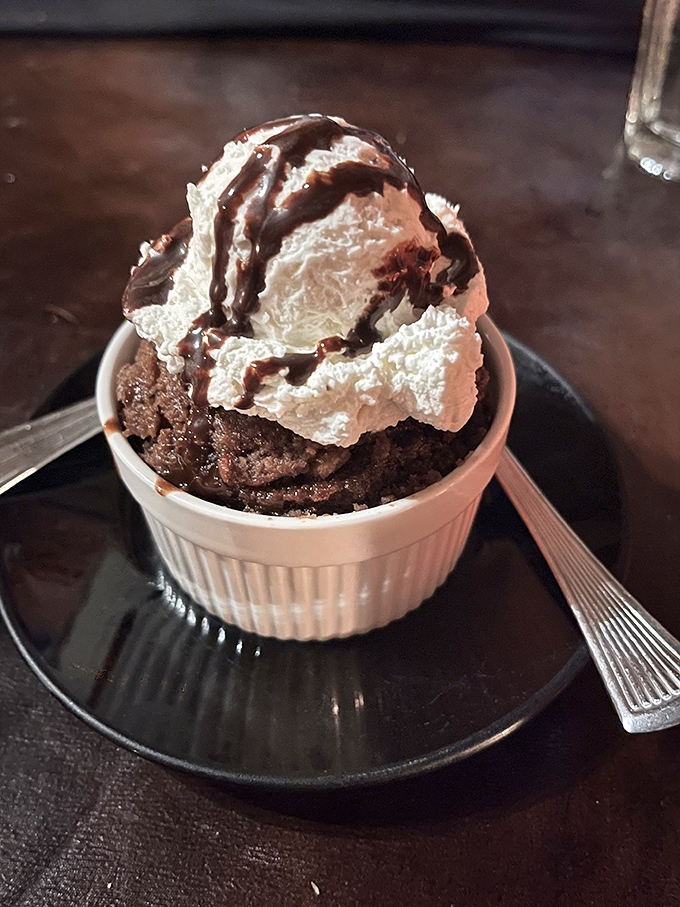 A warm chocolate dessert topped with cream and drizzled with sauce&mdash;because every epic meal deserves its sweet finale.