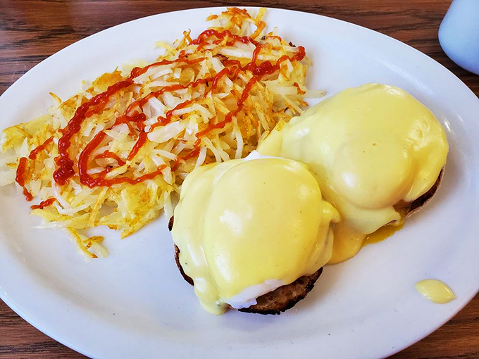Eggs Benedict that's dressed to impress, with hollandaise sauce flowing like yellow velvet. Those hash browns aren't just a side&mdash;they're a statement.