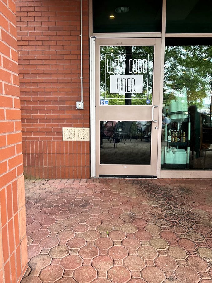 The threshold between ordinary day and extraordinary meal. This unassuming entrance leads to some of Georgia's most satisfying comfort food experiences.