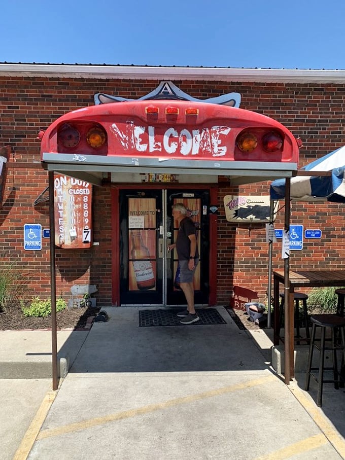 The entrance beckons with its distinctive red welcome sign &ndash; a barbecue beacon guiding hungry travelers to their smoked meat destiny.
