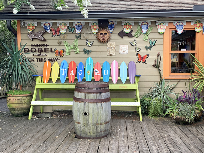 A rainbow of surfboards and whimsical butterflies&mdash;the entrance that says "Serious food served with a side of fun." Beach vibes perfected.