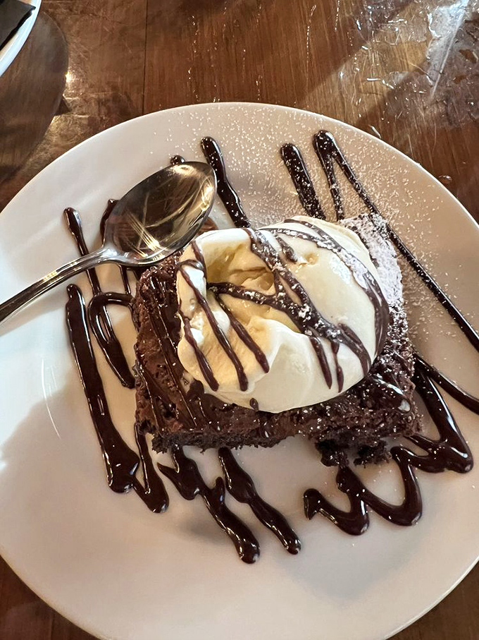 A flourless chocolate cake topped with ice cream and chocolate drizzle&mdash;because after conquering a steak, you deserve a victory dessert.