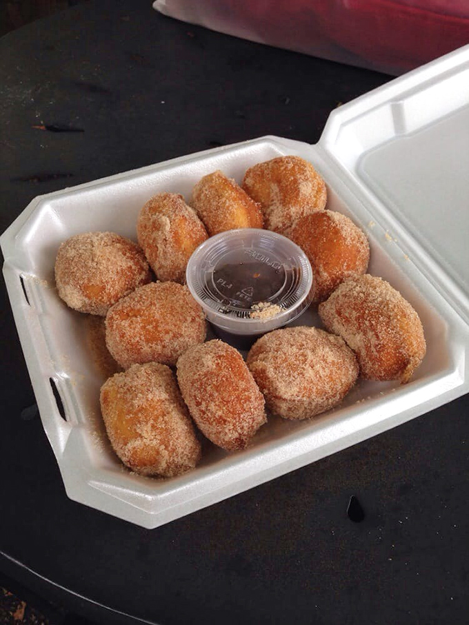 These aren't just fried biscuits—they're cinnamon-sugar-dusted orbs of joy that make adults remember what it's like to be kids again.