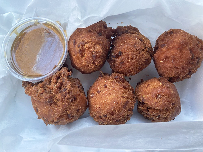 Hush puppies with the perfect golden crunch, served with honey butter that makes you question why you'd eat them any other way.