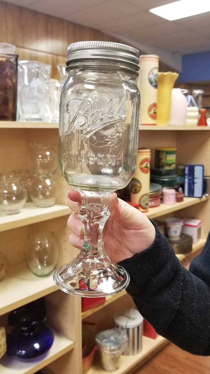 Someone's crafty upcycling turned a Mason jar into a wine glass—proof that thrift stores are where creativity and frugality have their best dates.