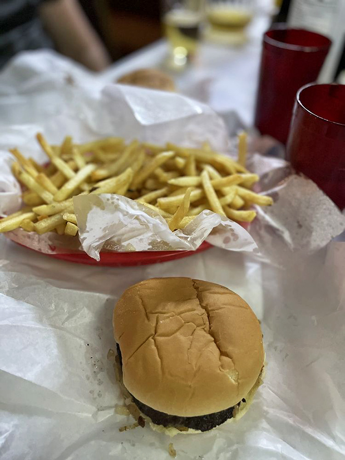The complete experience: a Jucy Lucy in its natural habitat, accompanied by fries and the anticipation of that first dangerous bite.