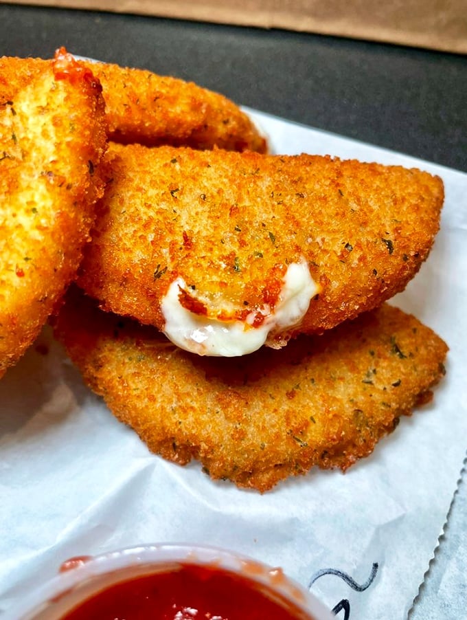 These aren't just mozzarella sticks; they're half-moon treasures of melty cheese waiting to stretch dramatically with each bite.