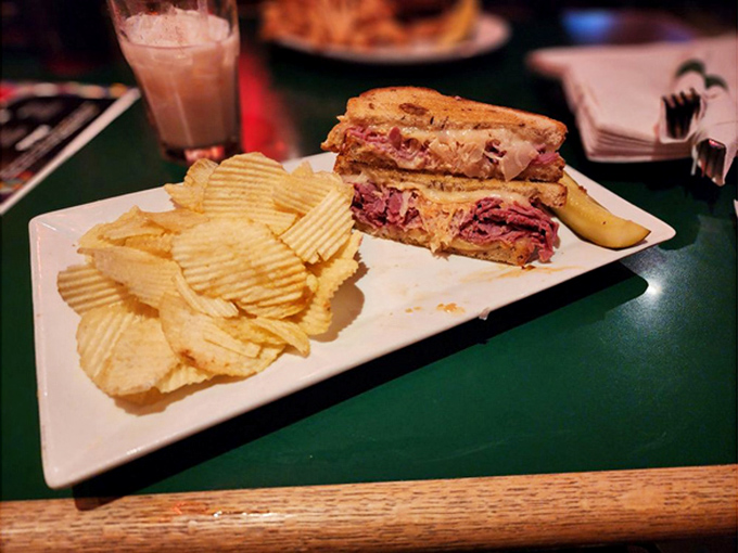 The Reuben arrives like a deli masterpiece&mdash;layers of history and flavor between toasted bread, with chips standing guard. 