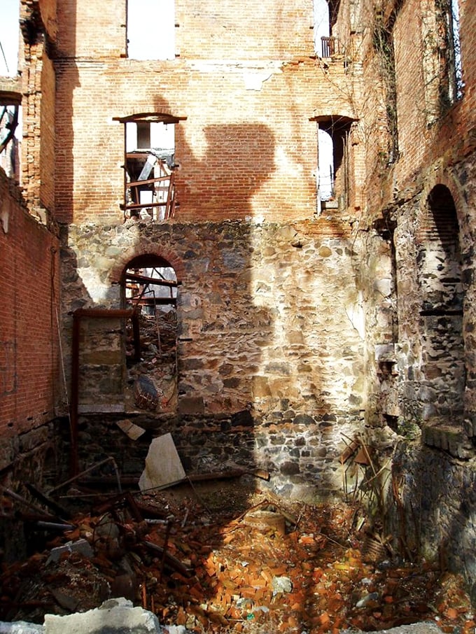 Interior walls tell silent stories. The combination of stone foundation and brick upper levels reveals construction techniques from another era.