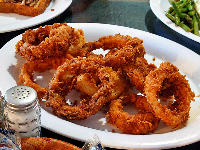 Onion rings with the perfect crunch-to-tenderness ratio. The salt shaker stands by, but these golden halos are already dressed for success.