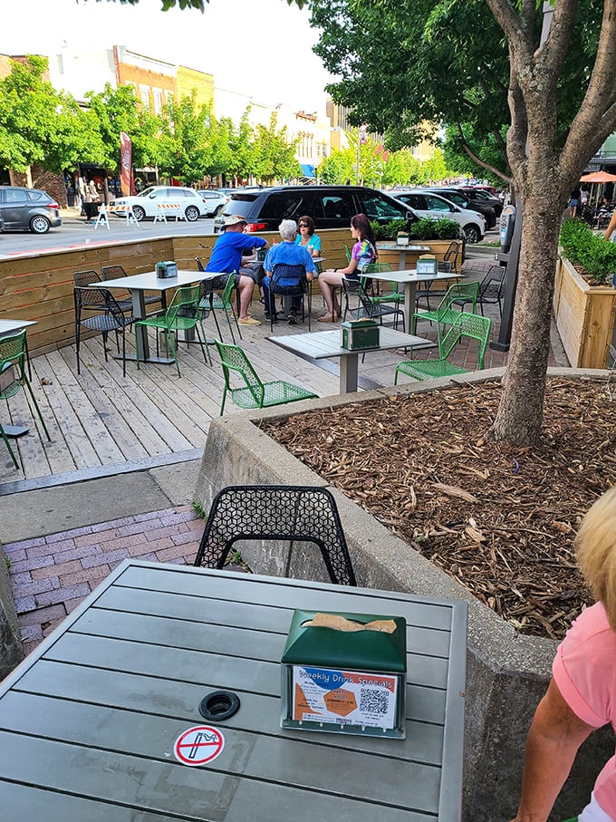 Outdoor seating where summer breezes complement burger bliss&mdash;nature's dining room with a side of people-watching.
