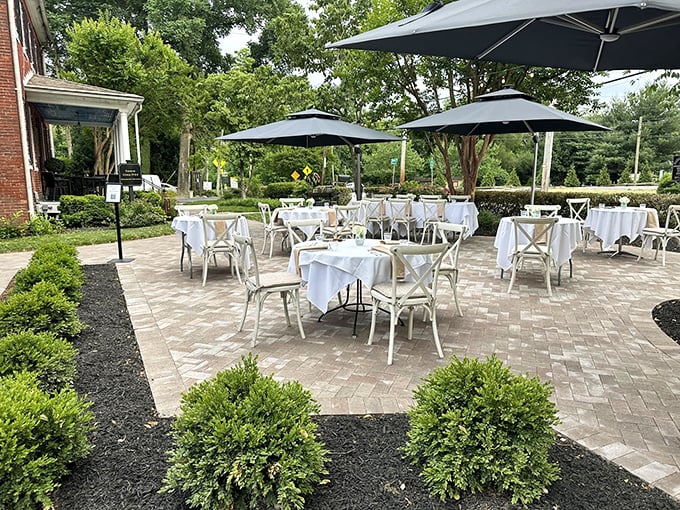 Al fresco dining done right! The patio's manicured setting offers a breath of fresh air with your meal, proving that sometimes the best ceiling is the sky.