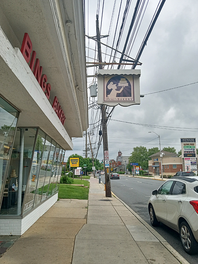 The charming hanging sign of Bing's Bakery serves as a beacon for sweet-seekers, guiding locals and visitors alike to Delaware's oldest bakery treasure.