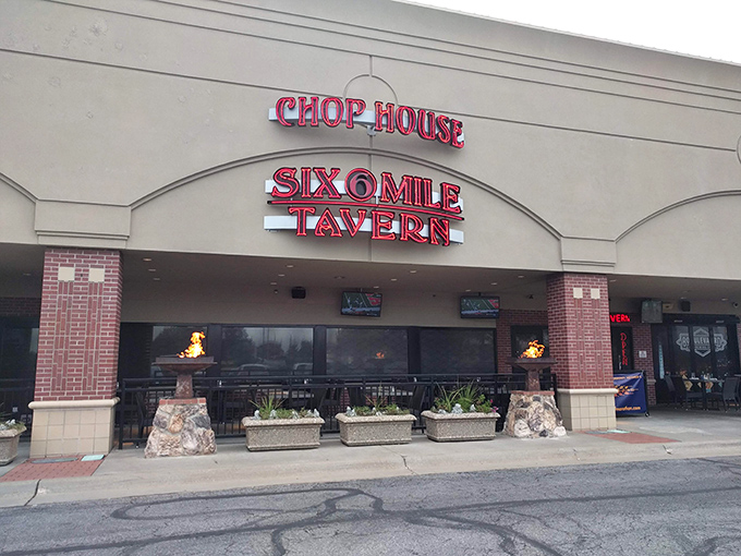 The neon glow of Six Mile's sign has guided countless hungry pilgrims to steak salvation. Those stone flame pillars aren't just decorative—they're beacons of beef brilliance.