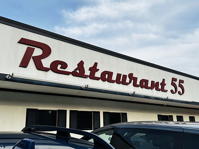 That bold red signage against the blue sky—like a beacon calling to hungry travelers. "Restaurant 55" isn't just a name, it's a destination.