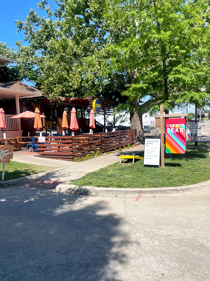 Outdoor seating under leafy trees makes summer chicken feasts even better. The wooden deck invites you to savor spicy bites in fresh air.