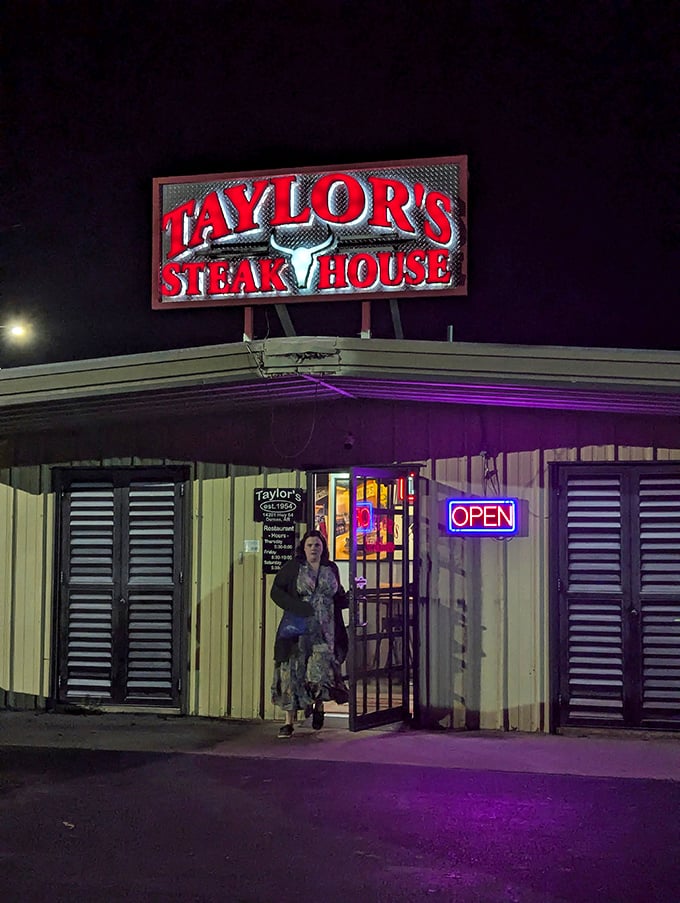 As night falls, the glowing Taylor's sign becomes a beacon for hungry travelers, promising salvation from mediocre meals and fast-food fatigue.