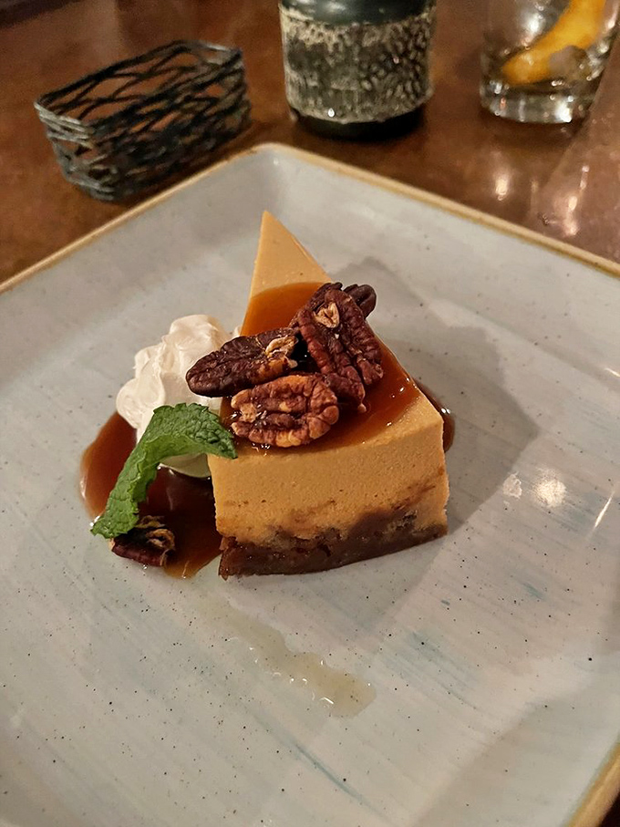 Pecan cheesecake that makes you wonder if dessert should actually come first. That caramel drizzle is performing a sweet symphony on the plate.