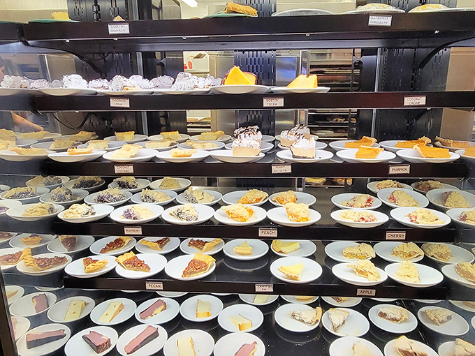 The dessert display that makes grown adults press their faces against the glass like kids at a toy store window. 