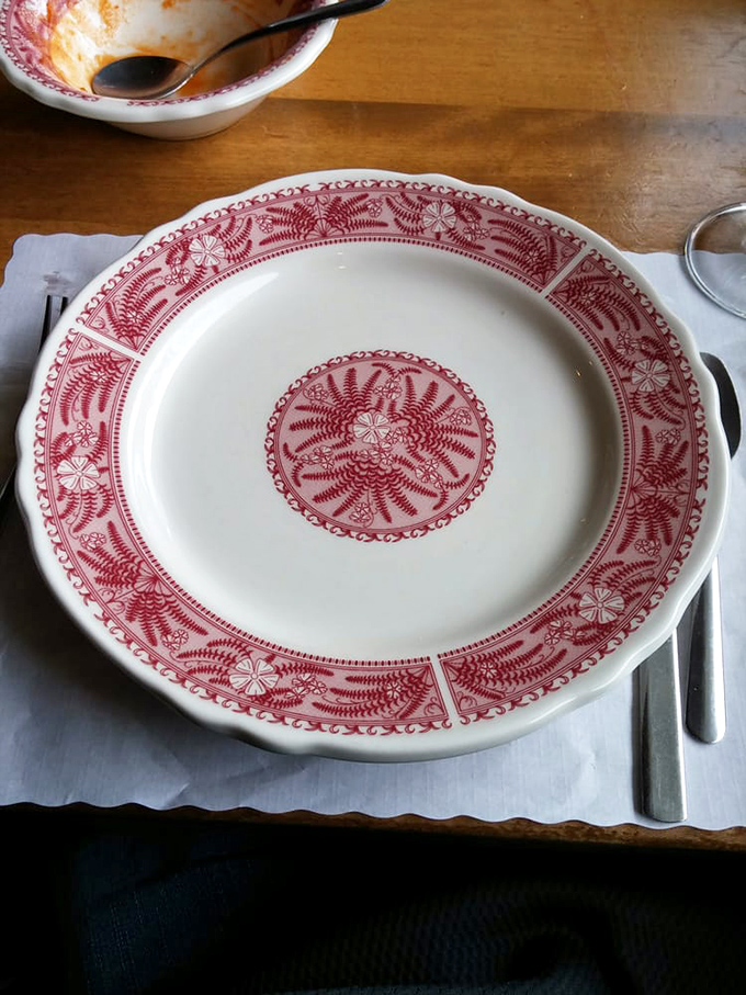 The distinctive red and white patterned plates have become as iconic as the meals they serve, waiting to be filled with Southern bounty.