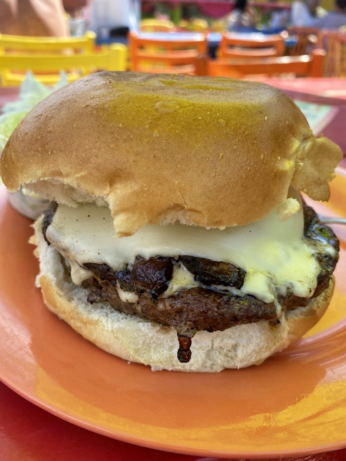 The outdoor seating area is a rainbow explosion of furniture where every table feels like the best seat in the house. 