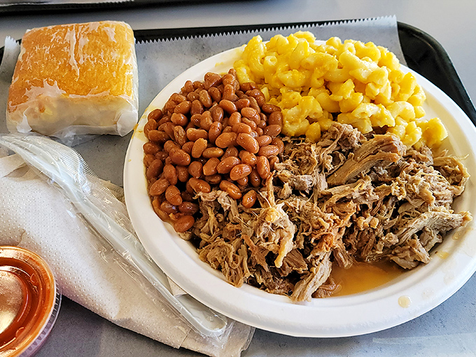 Pulled pork with all the fixings&mdash;tender meat alongside mac and cheese and pintos that prove side dishes are never an afterthought here. 