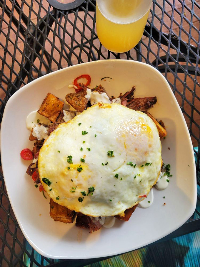 The Short Rib Hash arrives crowned with a sunny-side-up egg – breakfast's version of "put a ring on it."