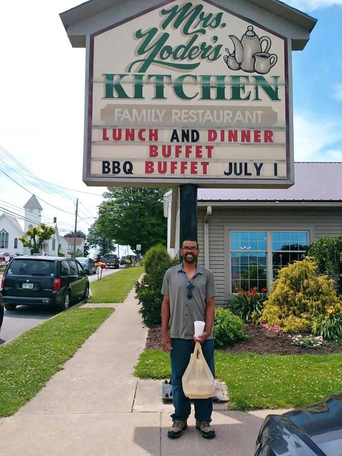 The sign promises BBQ buffet, but the smile says "I've found food heaven." Some pilgrimages involve mountains; the best ones involve mashed potatoes.