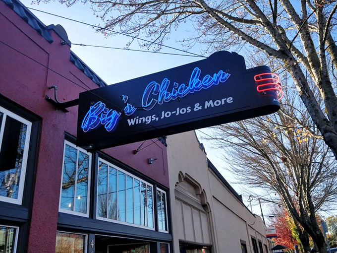 The pink building with that glowing blue sign is Portland's chicken beacon. No pretension, just a promise of poultry perfection inside. 