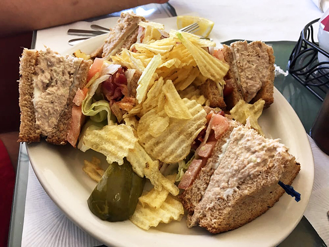 The club sandwich&mdash;lunch's answer to breakfast's dominance, stacked tall enough to require strategic first-bite planning.