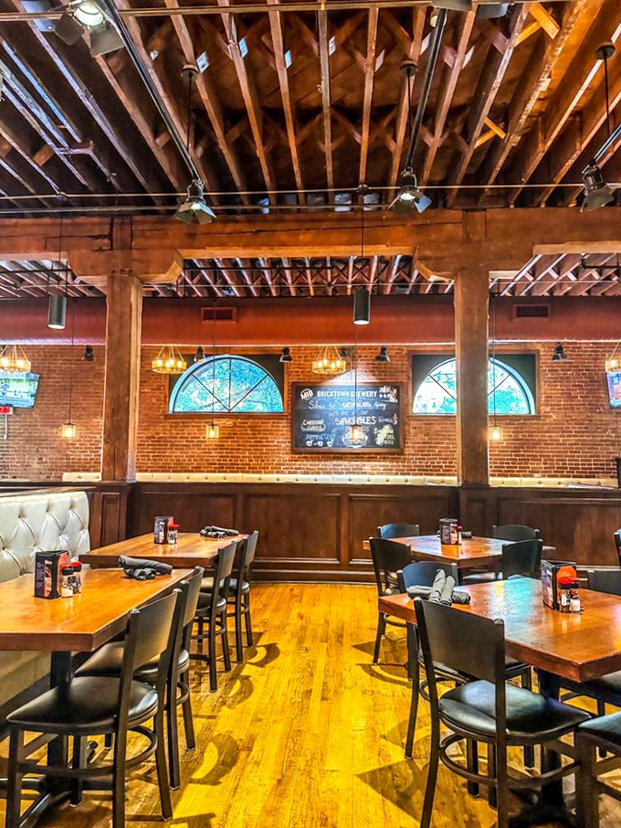 Warm wooden tones, exposed brick, and thoughtful lighting create an atmosphere that says "stay awhile" without having to say a word.