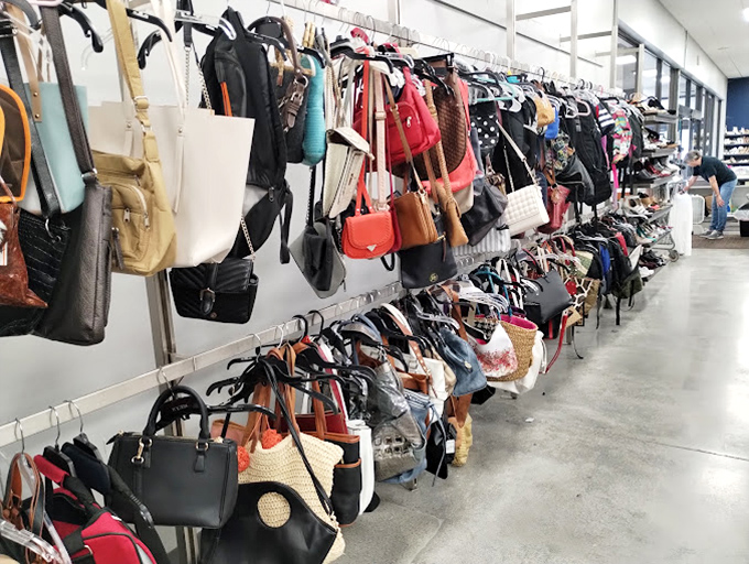 Handbags hang like ripening fruit, a leather and canvas orchard where vintage Coach might be hiding among everyday totes, waiting for the discerning eye.