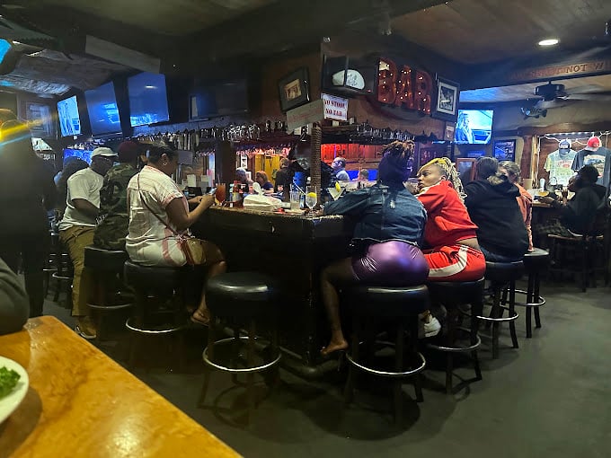 The bar at Spondivits isn't just where drinks are served - it's where seafood stories are swapped and Atlanta memories are made.