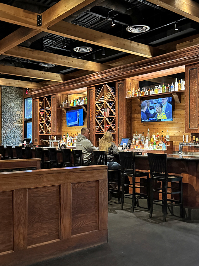 A bar that says "pull up a stool and stay awhile" without saying a word. Those wooden wine racks aren't decoration&mdash;they're a promise of good times ahead.
