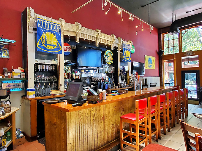 The bar area isn't just serving drinks &ndash; it's serving community spirit with Warriors banners proudly declaring "this is Oakland's place."