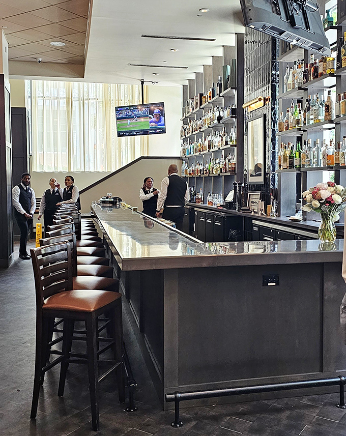 A bar meticulously stocked like a library of liquid treasures. The staff stands ready to mix your perfect libation with the seriousness it deserves.