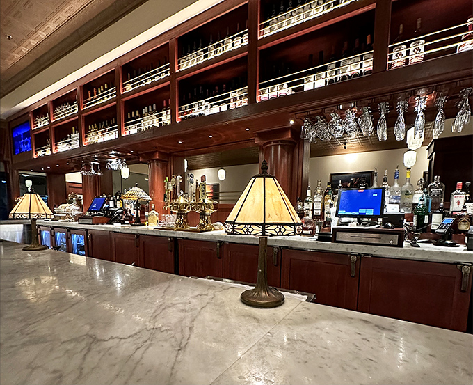 A bar that says "pull up a stool and stay awhile"&mdash;gleaming marble, warm wood, and enough bottles to make decision-making the only real work you'll do tonight.