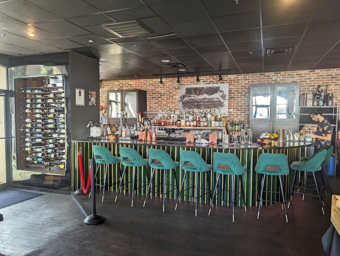 The bar beckons with turquoise chairs and bottles standing at attention&mdash;like a well-orchestrated prelude to an evening of culinary adventure.