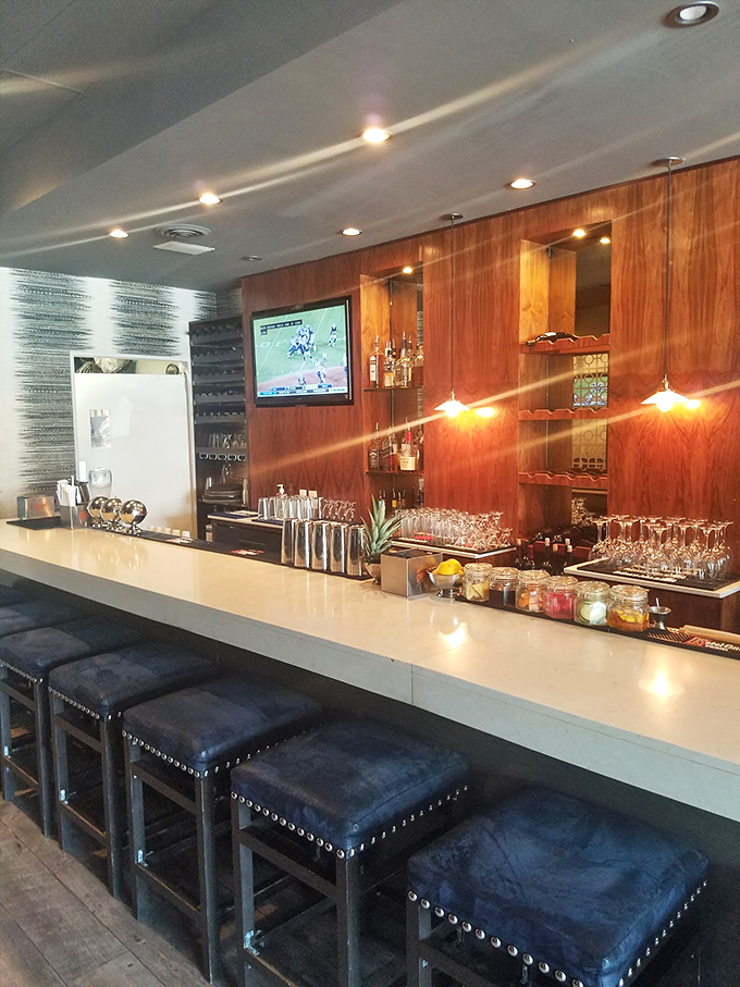 The bar invites you to linger awhile. Warm wood tones, comfortable seating, and the promise of perfectly crafted drinks make a compelling case.