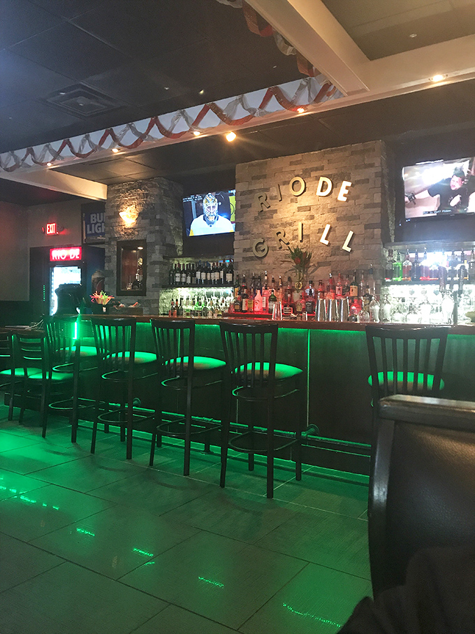 The bar at Rio De Grill glows with emerald promise, a beacon of caipirinha possibilities for when your meat-induced euphoria needs a liquid companion.