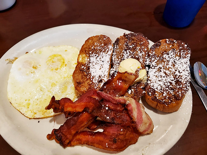 French toast dusted with powdered sugar alongside bacon cooked to that perfect point between chewy and crisp. Breakfast nirvana on a plate.