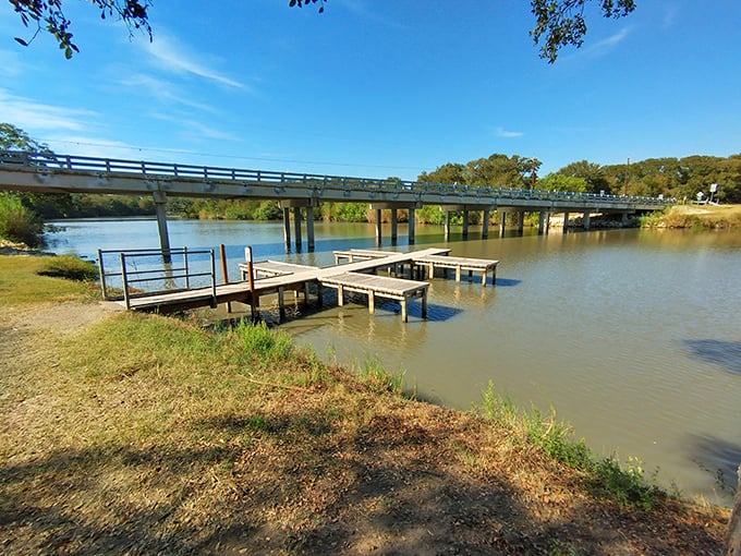 The fishing pier extends like a welcoming handshake into the water, offering anglers prime real estate for their patience-testing hobby.