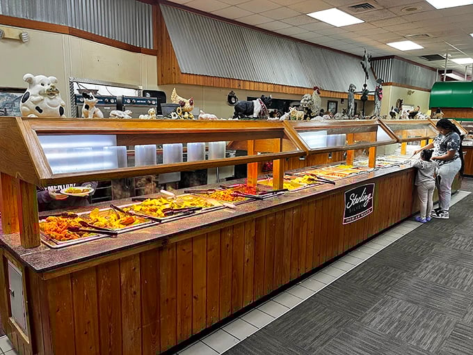 The buffet line stretches like a golden-hued highway of Southern delights, with steam rising from trays of freshly replenished comfort classics.