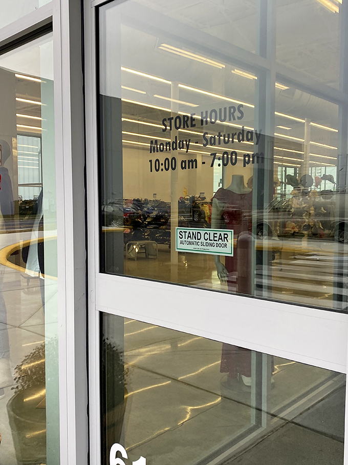 Store hours posted with the promise of retail adventure six days a week. The automatic door is just the beginning of your journey.