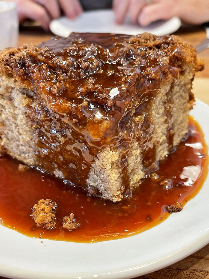 This isn't just cake &ndash; it's a gravity-defying tower of caramel-drenched perfection. The pool of sauce ensures not a single bite misses out on that sweet, buttery flavor.