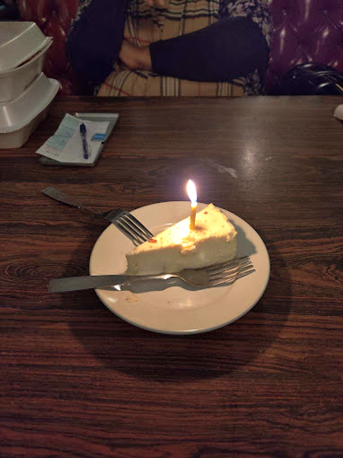 A single candle illuminates cheesecake perfection &ndash; because birthdays, anniversaries, and Tuesday nights all deserve a proper finale.